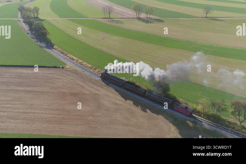 Aerial over head view of an antique restored steam locomotive traveling ...