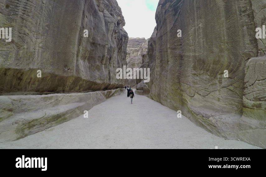 PETRA, JORDAN - circa JAN, 2017: People in narrow passage, red gorge ...