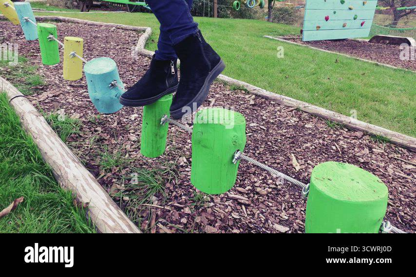 Teen feet passing through obstacles in a Rope Park Challenge, closeup ...