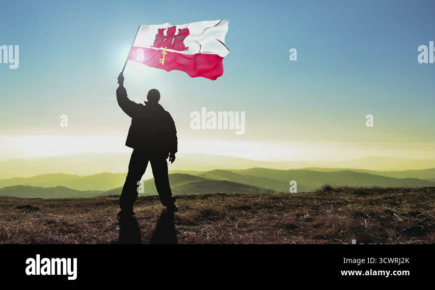 Successful silhouette man winner waving Gibraltar flag on top of the ...