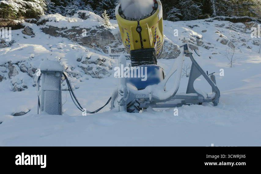 Large snow gun generates artificial snow on ski slope Stock Video ...