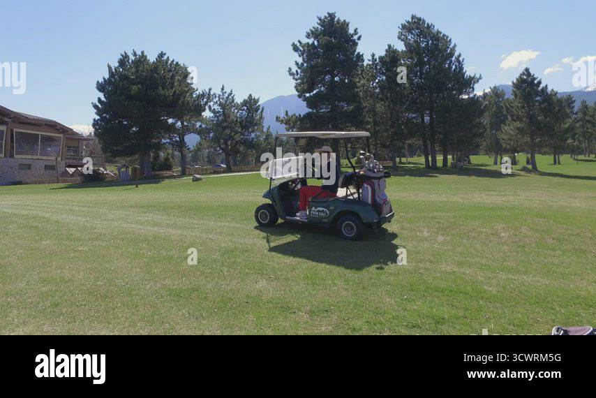 BANSKO, BULGARIA - circa APRIL, 2017: Players drive a golf cart around ...