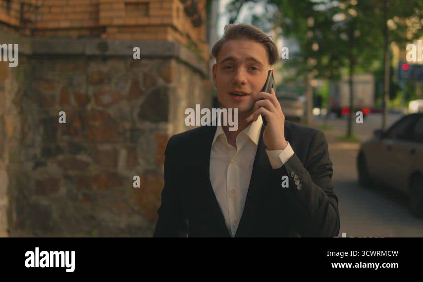 fair guy talking by mobile in town Stock Video Footage - Alamy