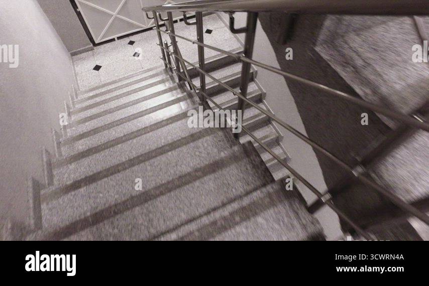 Going down the stairs so fast. It is a stairs in a fire exit in a ...