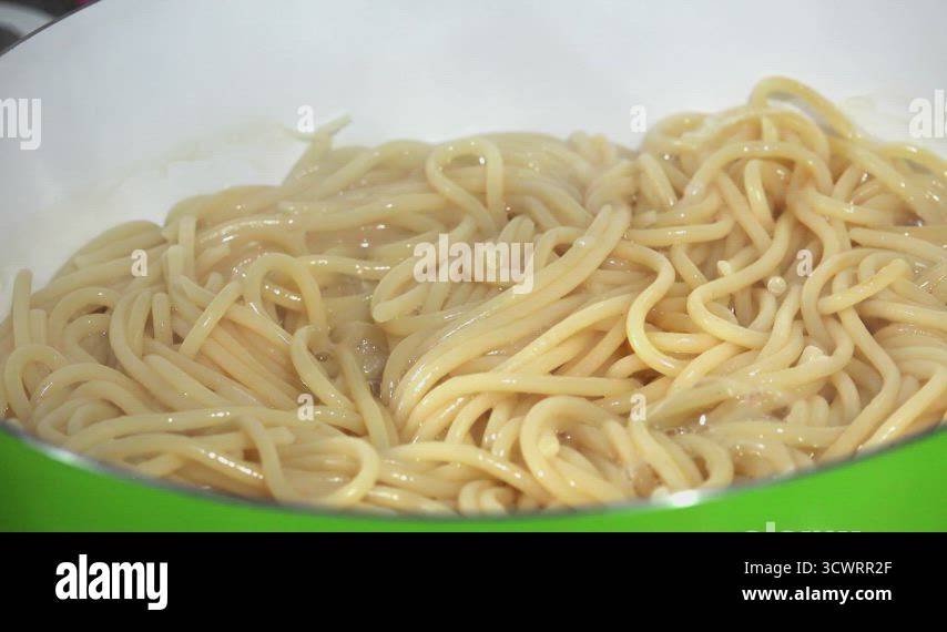 Boiling spaghetti in pan on electric stove in the kitchen, LOOP Stock ...