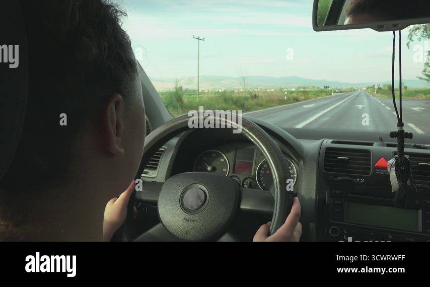 Attractive Teen Driver Looks In Rearview Mirror, face reflection on ...