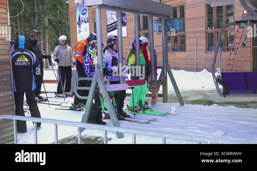 BANSKO, BULGARIA - circa FEB, 2016: Skiers at ski lift entrance gate ...