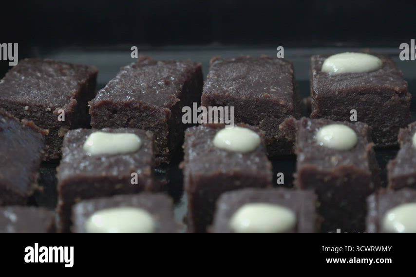 Pouring chocolate on cube brownies cakes, home preparation Stock Video ...