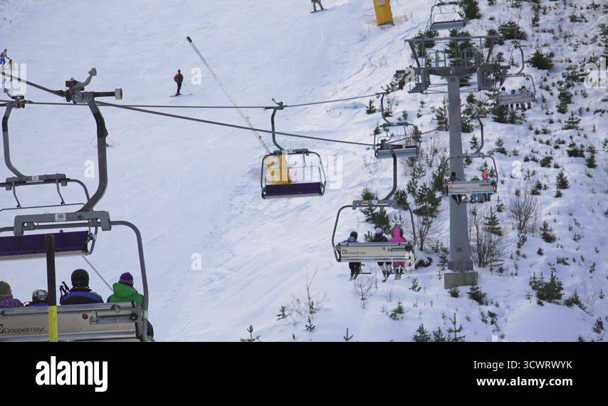 BANSKO, BULGARIA - circa FEB, 2016: Ski lift takes Skiers at the top of ...