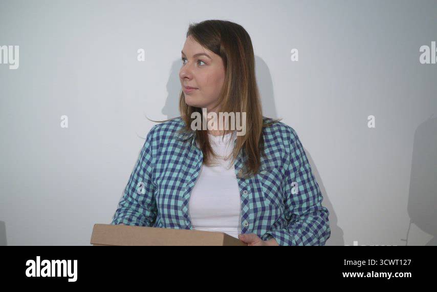 Woman with cardboard boxes, delivery girl holds and drops things ...
