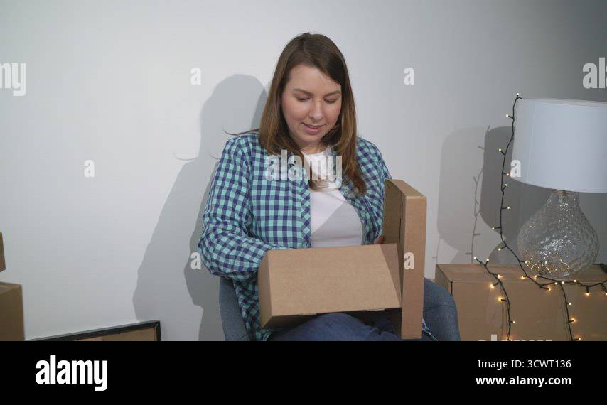 Woman with cardboard boxes, delivery girl holds and drops things ...
