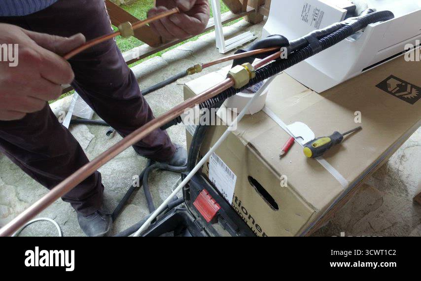 Installing air conditioner pipes Stock Video Footage - Alamy
