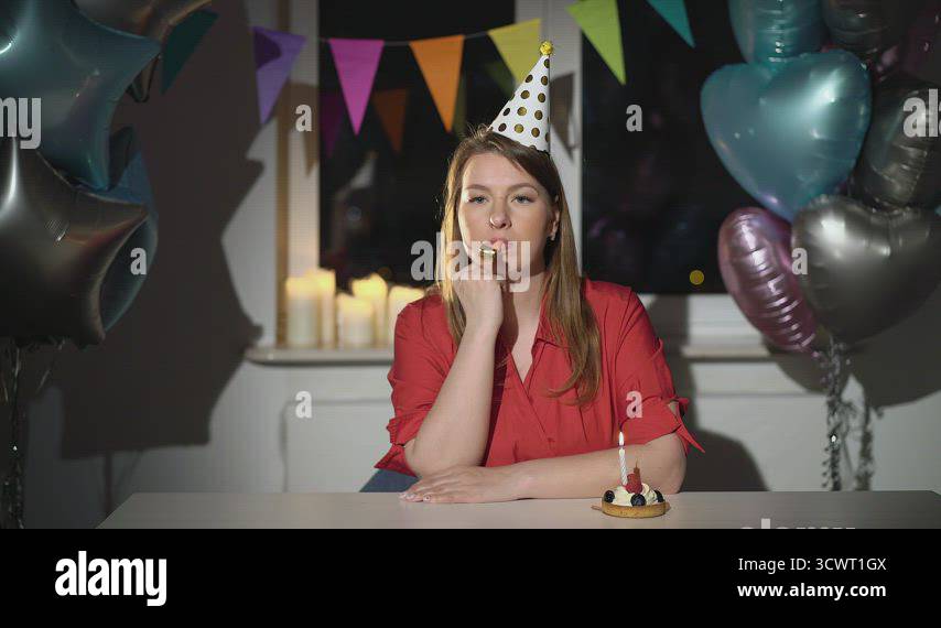 Young woman celebrating her birthday alone. Sad bored and tired girl ...