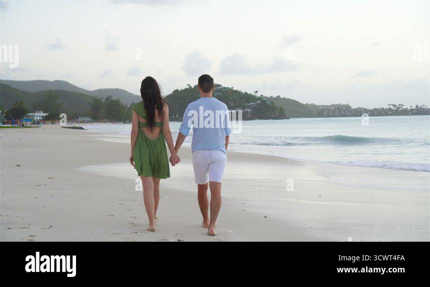 Young couple on tropical beach with white sand and turquoise ocean ...