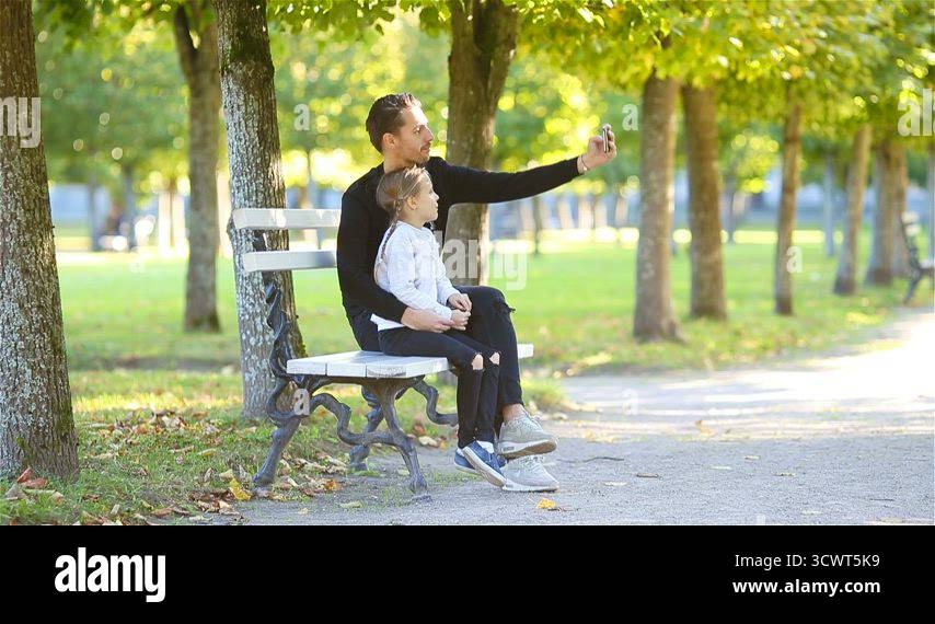 Happy family in fall. Father and little kid have fun taking selfie on ...