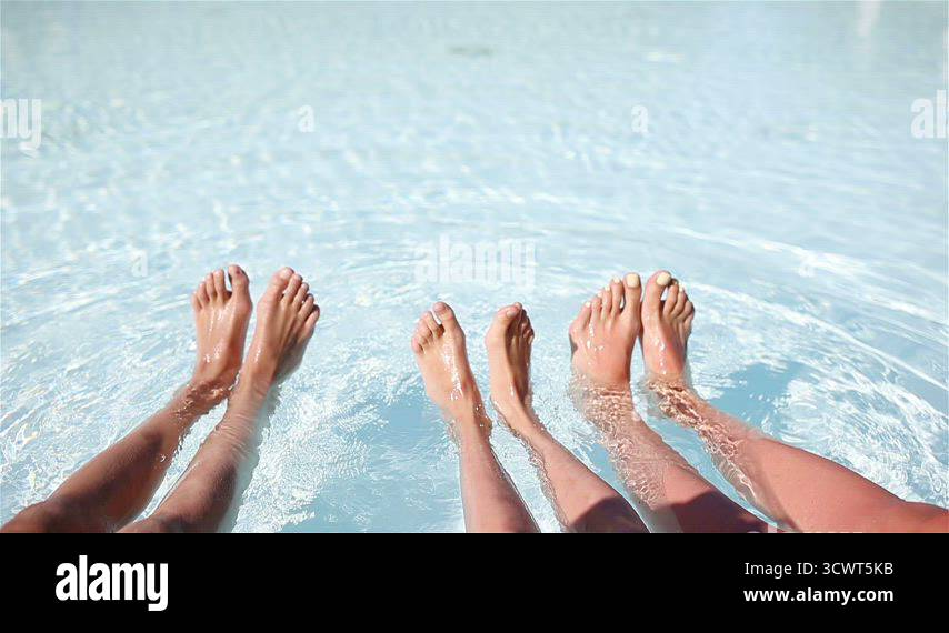 Close up of four people's legs by pool side Stock Video Footage - Alamy