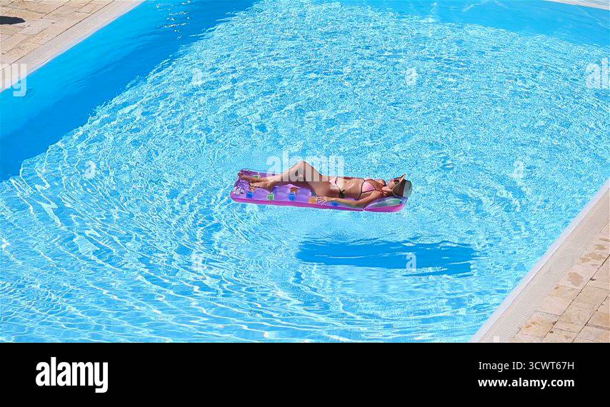 Young woman in bikini air mattress in the big swimming pool Stock Video ...