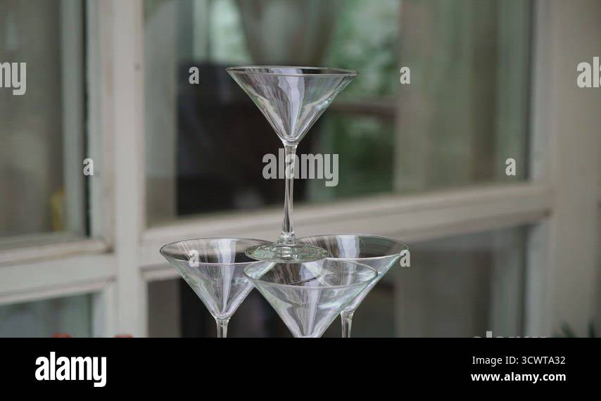 Pyramid tower of glasses with champagne. Sparkling alcohol wine at the ...
