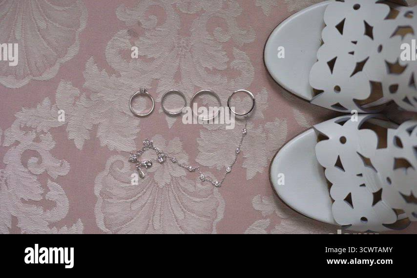 Wedding rings and bridal shoes. Pair of marriage symbols. Love of bride ...