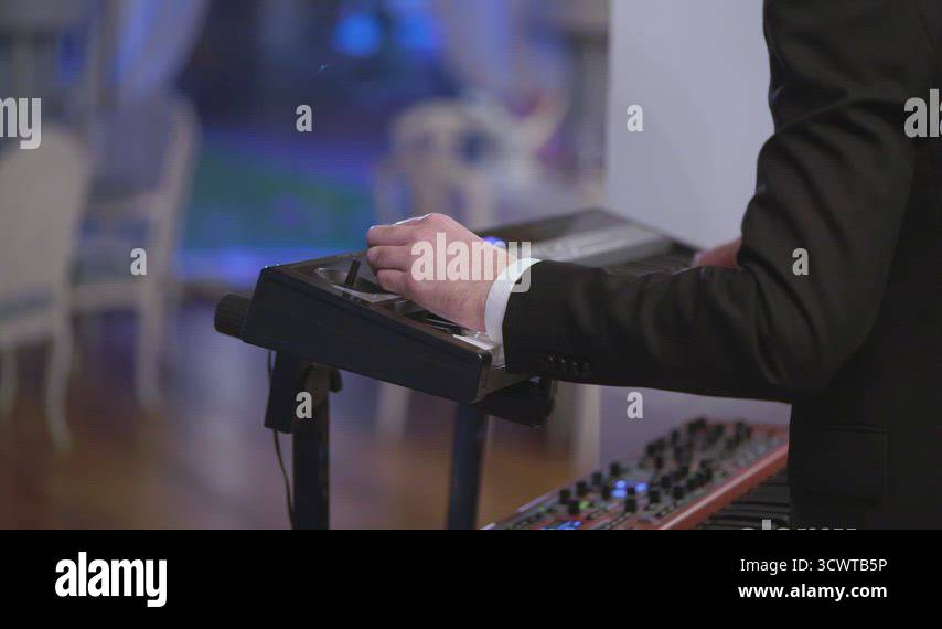 Musician playing electronic keyboard synthesizer piano. Band at concert ...