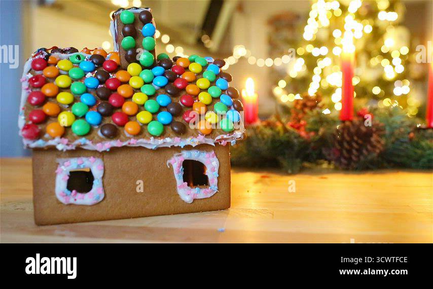 Gingerbread fairy house on a background of bright Christmas tree with ...