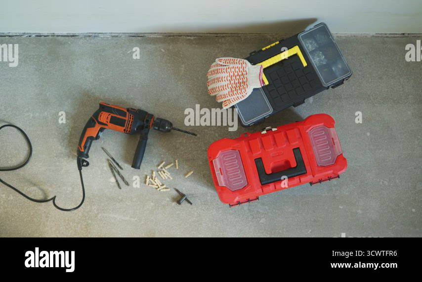 Work tools - electric drill, laser level, box with instruments and ...