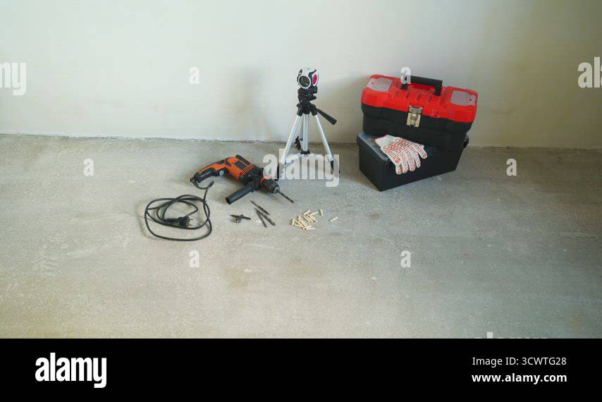 Work tools - electric drill, laser level, box with instruments and ...
