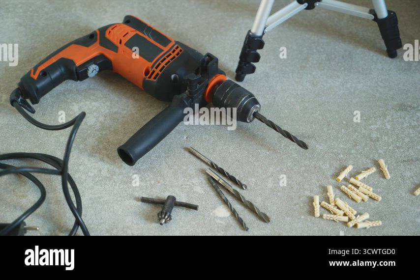 Work tools - electric drill, laser level, box with instruments and ...