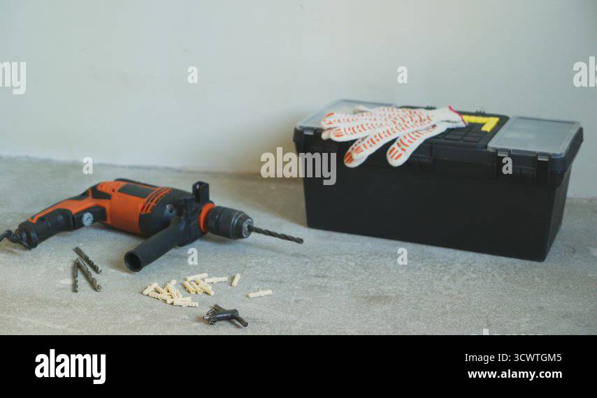 Work tools - electric drill, laser level, box with instruments and ...