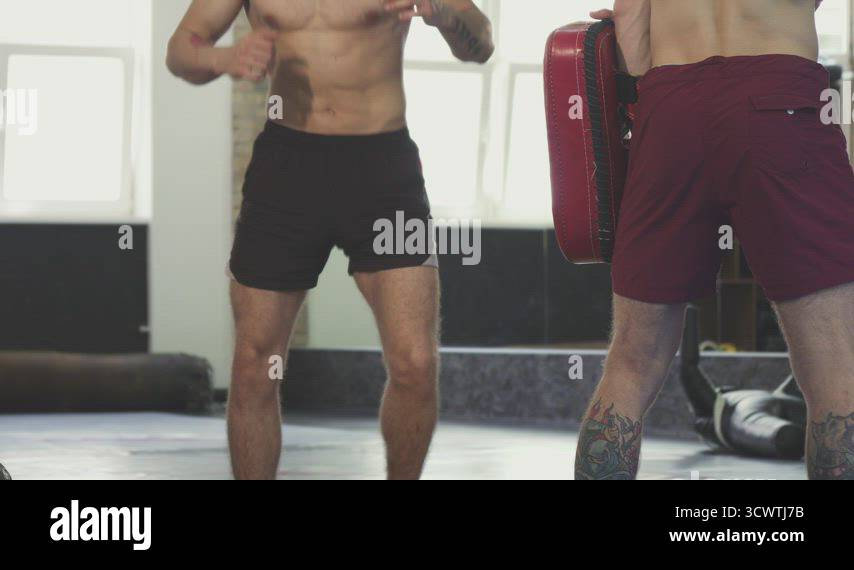 Cropped shot of a professional kickboxer training with his coach Stock ...