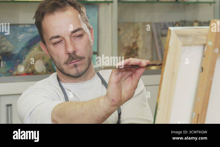 Professional artist concentrating over his painting Stock Video Footage ...