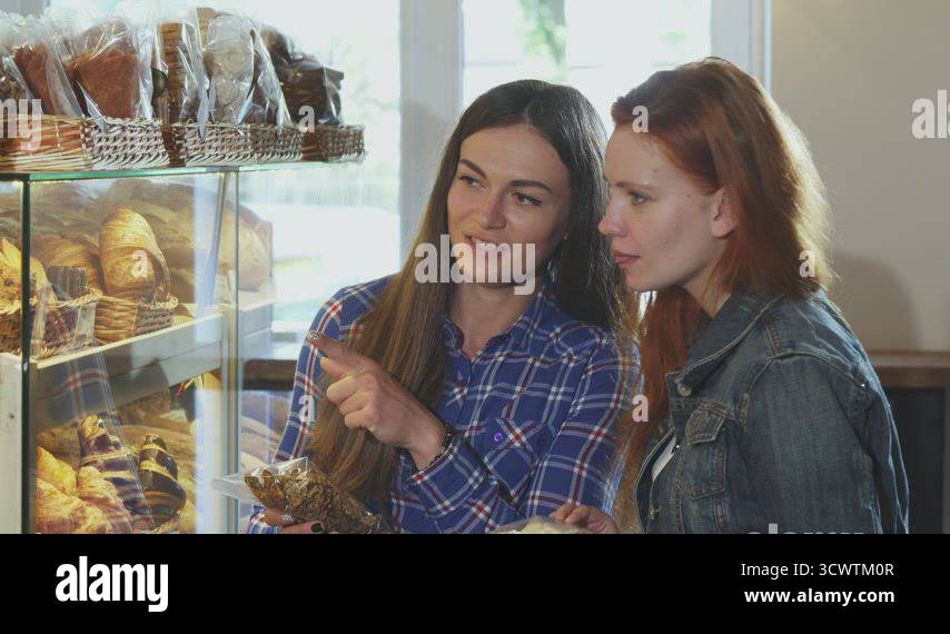 Female friends choosing cookies at the bakery shop Stock Video Footage ...