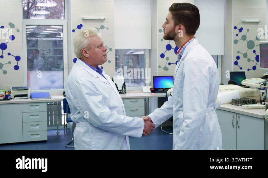 Two male scientists greet each other at the laboratory Stock Video ...