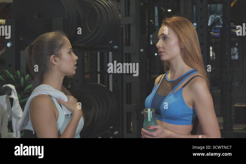 Cheerful female friends high fiving after finishing working out at the ...