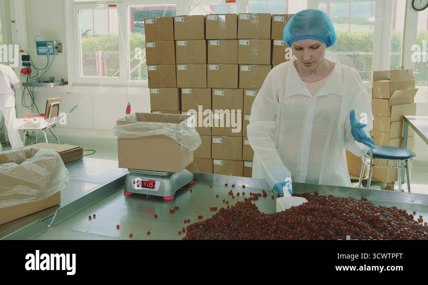 Factory worker packing candies. Candy factory Stock Video Footage - Alamy