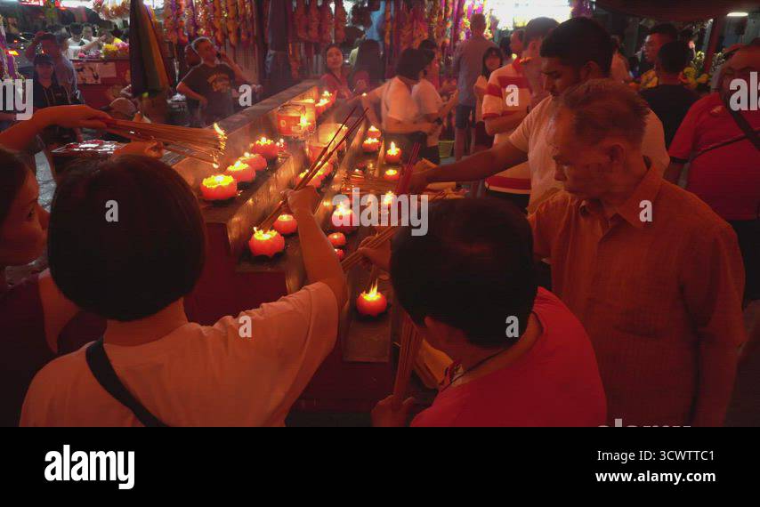 Chinese pray at temple by light up the lotus candle Stock Video Footage ...