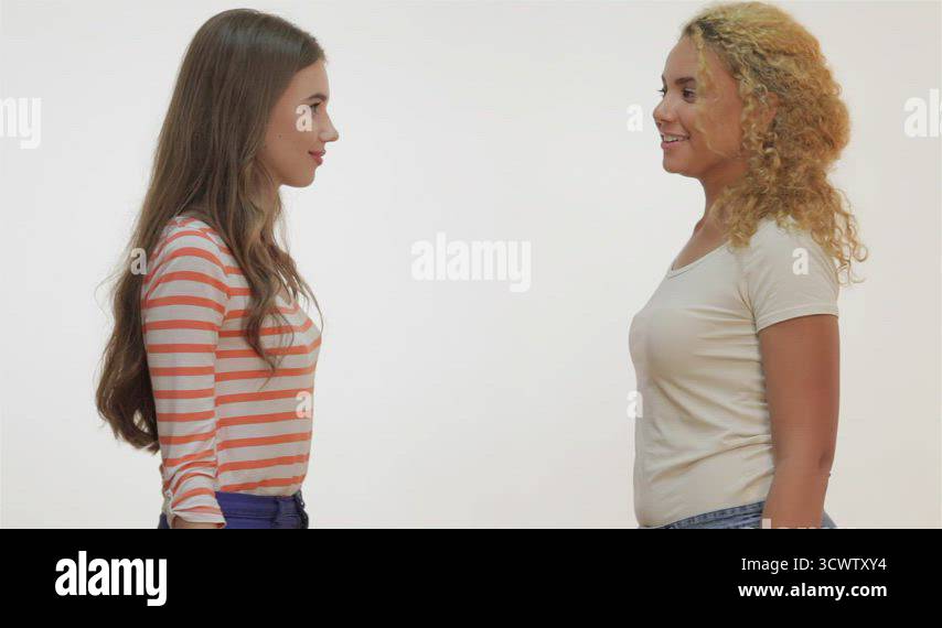 Attractive young girls smile and clap each other palms Stock Video ...