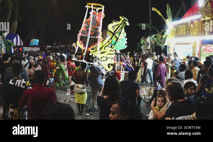 Devotees carrying kavadi and extreme body piercing dance at street ...