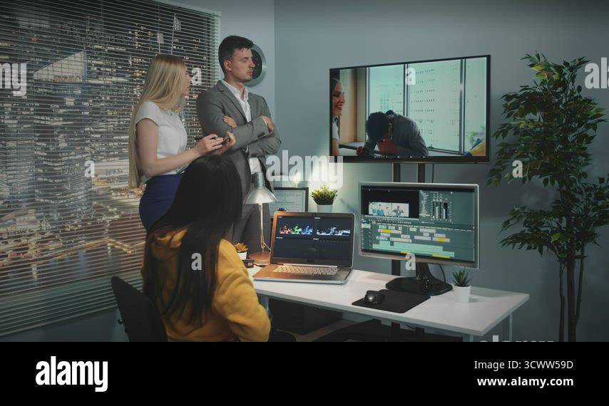 Mixed race team of video editors listening to chief commenting video ...