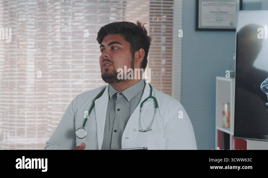 Close-up of mixed race doctor in lab coat talking about athlete's brain ...