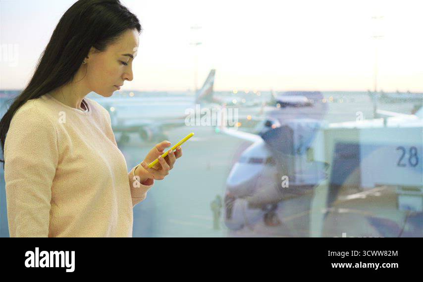 Airline passenger in an airport lounge waiting for flight aircraft ...