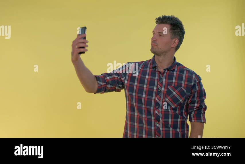 Attractive tall boy making selfie on smartphone Stock Video Footage - Alamy
