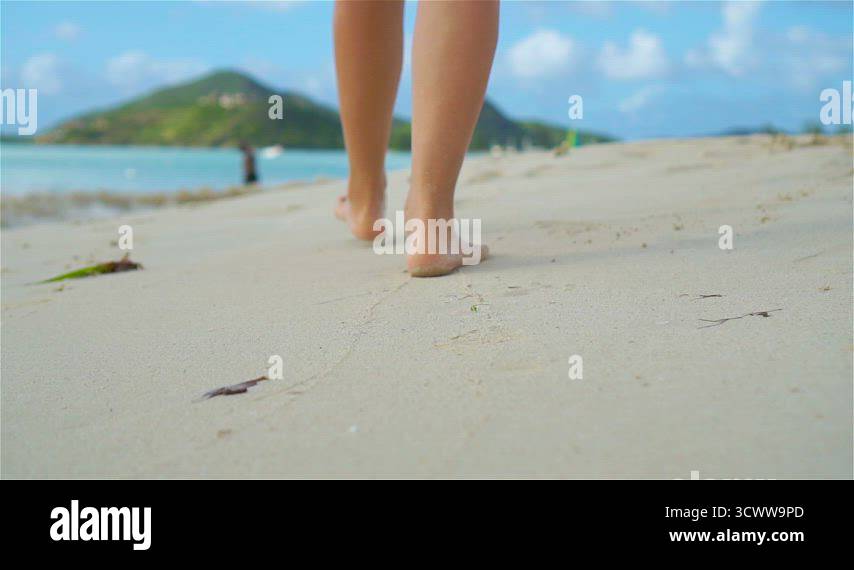 Close up female feet walking barefoot on the beach. Slow Motion Stock ...