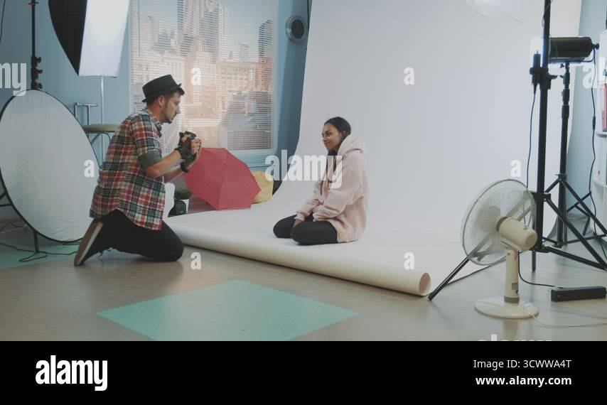 Backstage of the photo shoot: black model posing on the floor for a ...
