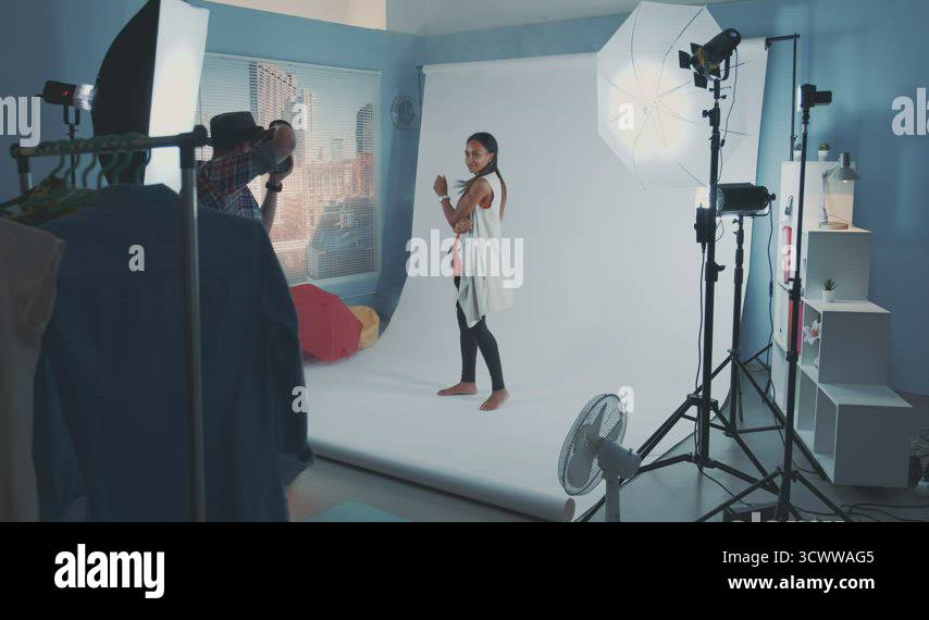 Photo shoot backstage: young african model posing on white background ...
