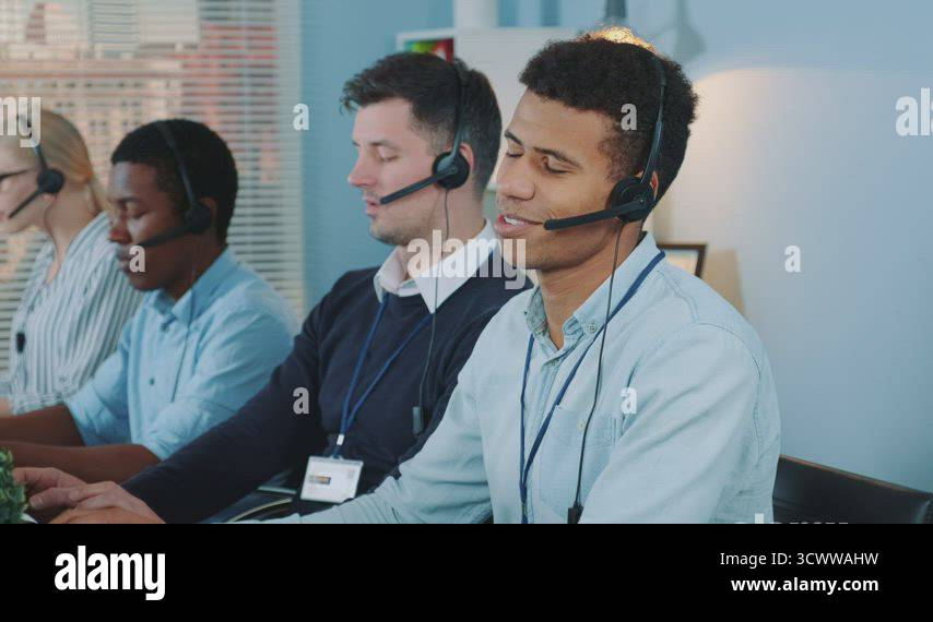 Medium shot of black call center agent feeling exhausted and broken ...