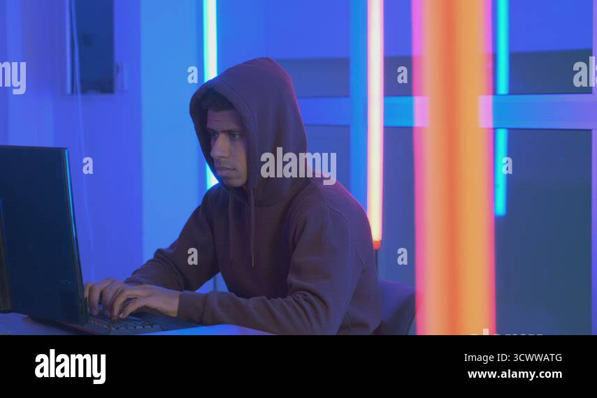 African hacker dressed in hoodie working on the computer Stock Video ...