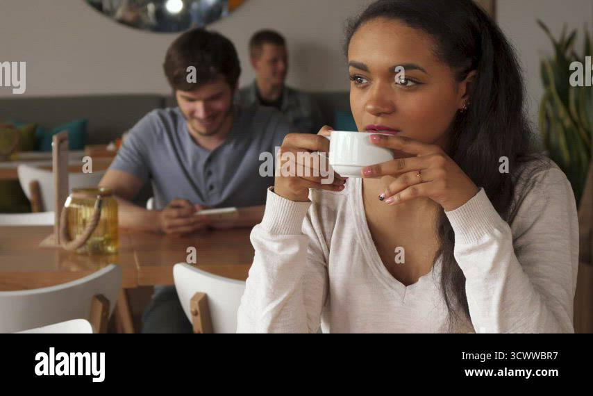 Girl dreams over the cup of coffee at the cafe Stock Video Footage - Alamy