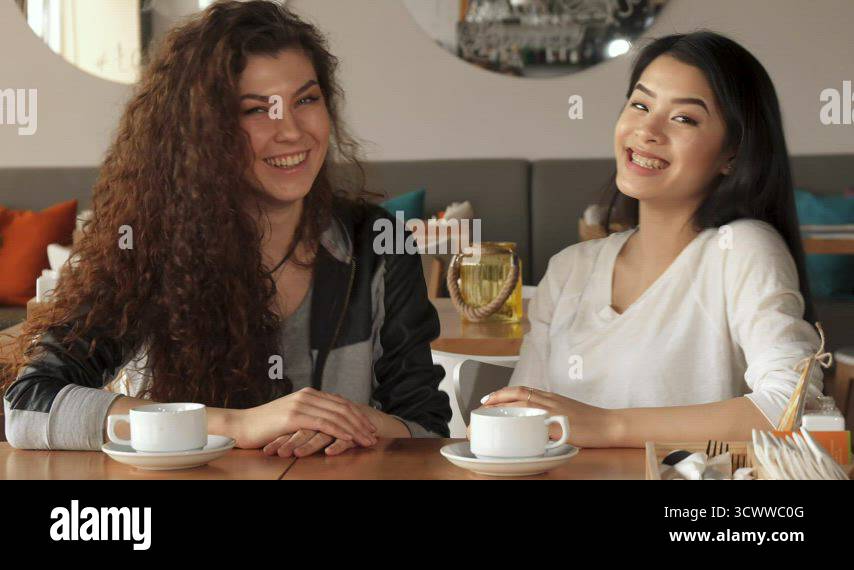 Two friends gesture love at the cafe Stock Video Footage - Alamy