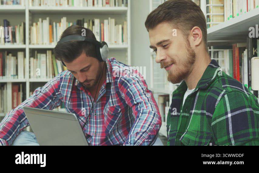 Two cute guys spend their free time in the library Stock Video Footage ...